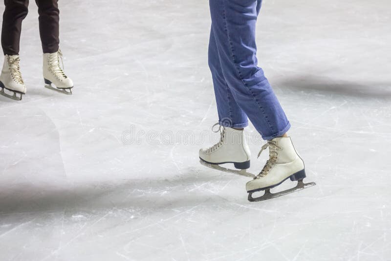 Feet on the Skates of a Person Rolling on the Ice Rink Stock Image ...