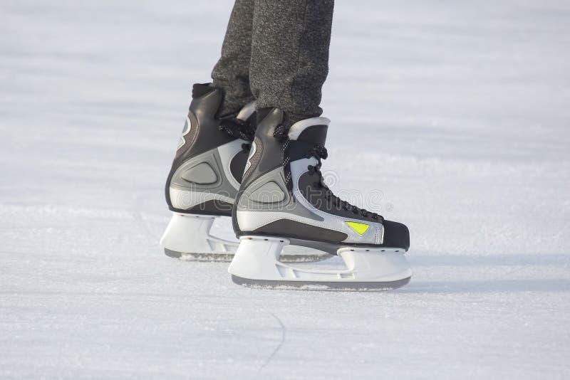 Feet on the Skates of a Person Rolling on the Ice Rink Stock Image ...