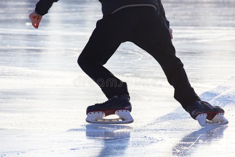 Feet on the Skates of a Person Rolling on the Ice Rink Stock Photo ...
