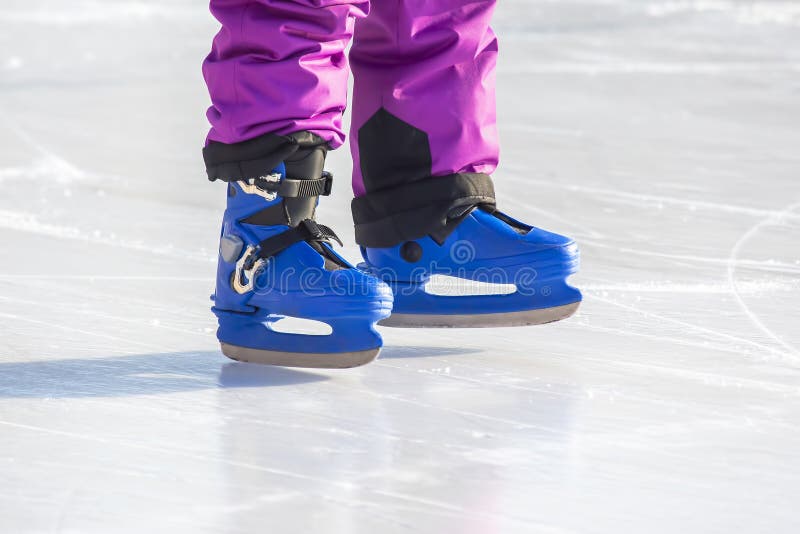 Feet on the Skates of a Person Rolling on the Ice Rink Stock Photo ...