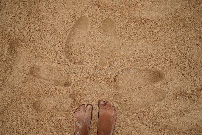 Feet and Three Footprints in the Sand Stock Photo - Image of stand ...