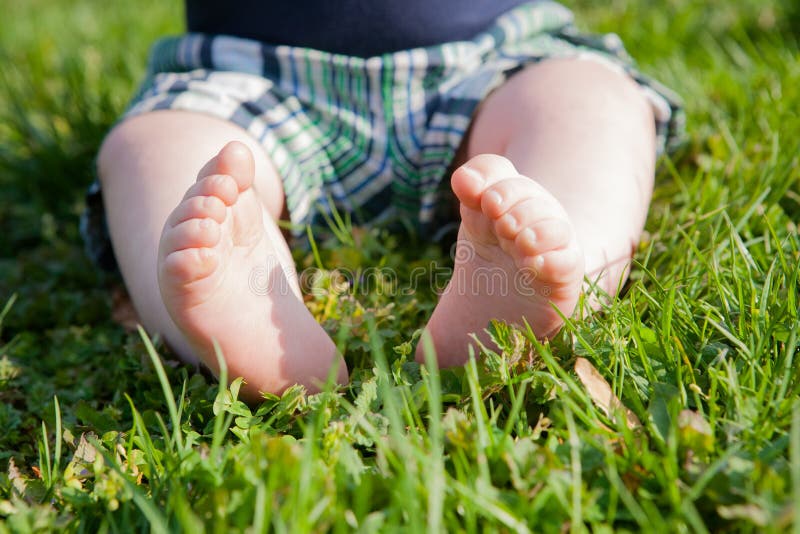 Feet of Toddler Sitting in Grass Stock Image - Image of feet, spring ...