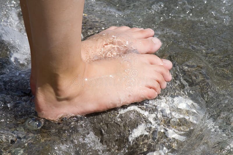 Feet in water stock image. Image of young, rocks, shallow - 5770143