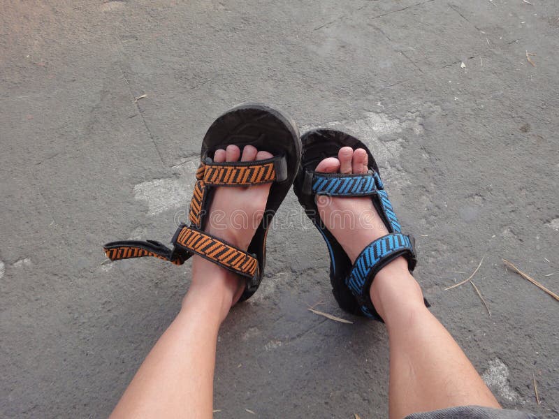 The Feet that Wear Sandals are of Different Colors Stock Photo - Image ...