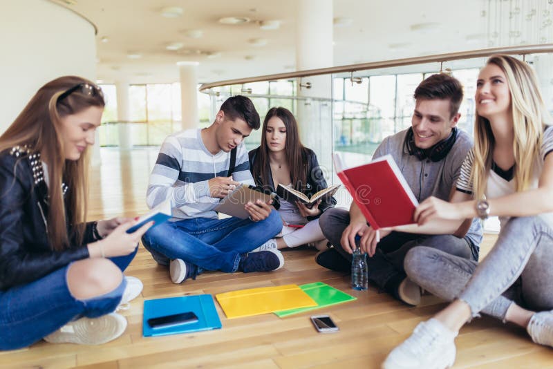 Students Sitting on Floor in Campus and Preparing Together for Exams ...
