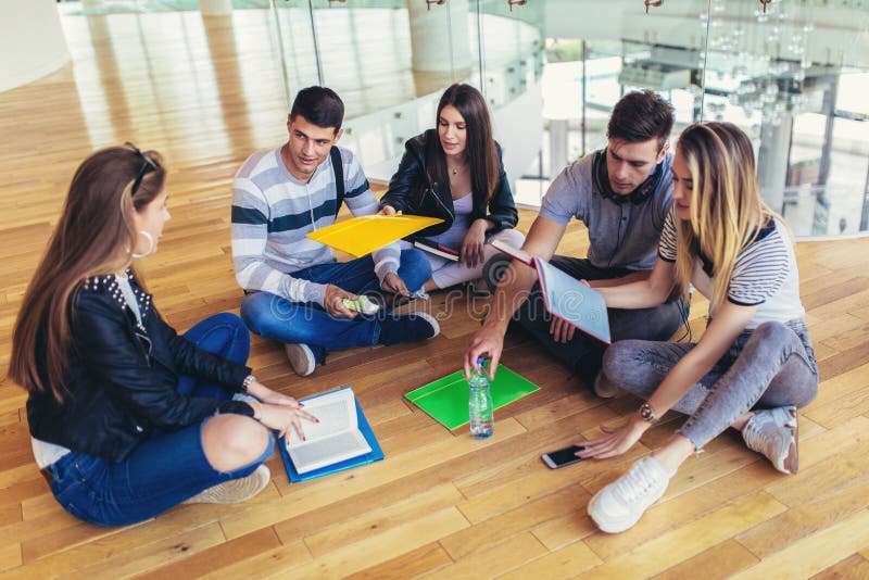 Students Sitting on Floor in Campus and Preparing Together for Exams ...