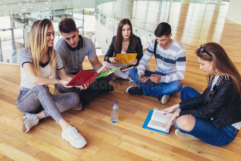 Students Sitting on Floor in Campus and Preparing Together for Exams ...