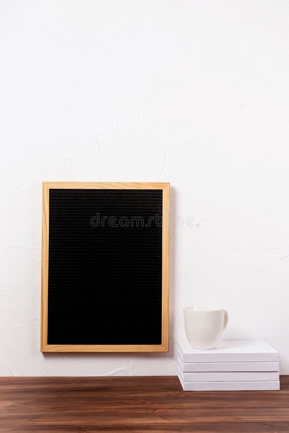 Felt Letter Board Hanging on the Wall with Stack of Books and Coffee ...