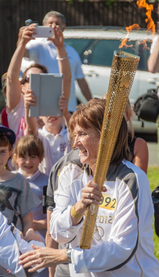 Female 2012 Olympics Torch Bearer. Editorial Photo - Image of running ...