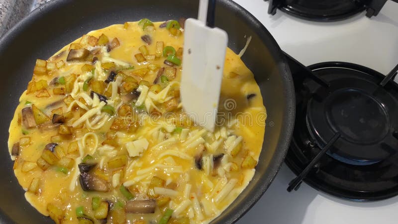 Female Adding Eggs into a Frying Pan with Vegetables Stock Footage ...