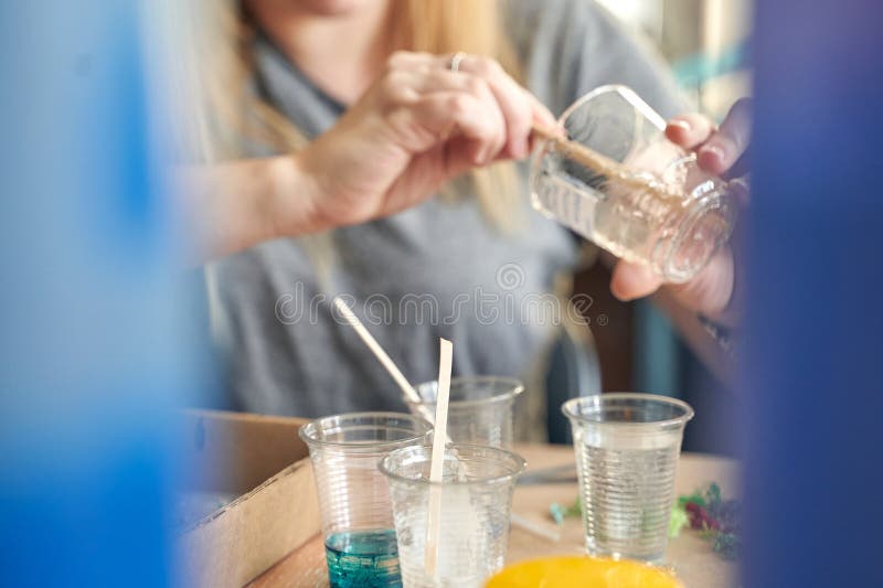 Female Adult Pouring Liquid into Clear Plastic Cups with Stirring ...