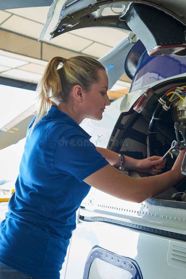 Portrait of Female Aero Engineer Working on Helicopter in Hangar Stock ...