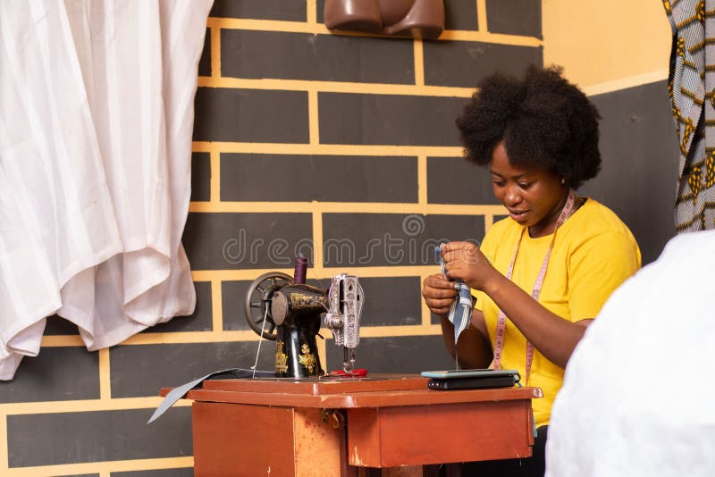 Female African Tailor Sewing with Her Machine Stock Photo - Image of ...