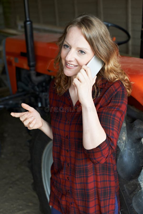 Female Agricultural Worker with Tractor Making Phone Call Stock Photo ...