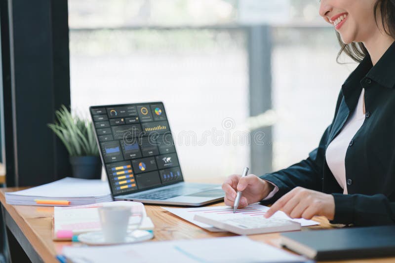 The Female Analyst Utilizes a Computer and a Dashboard for Business ...