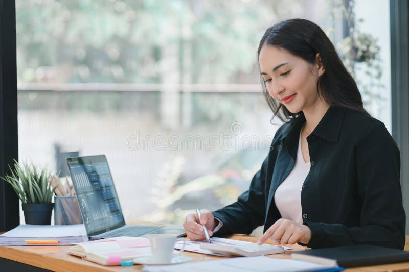 The Female Analyst Utilizes a Computer and a Dashboard for Business ...