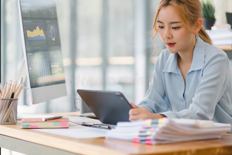 The Female Analyst Utilizes a Computer and a Dashboard for Business ...