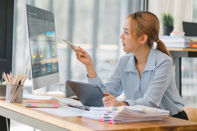 The Female Analyst Utilizes a Computer and a Dashboard for Business ...