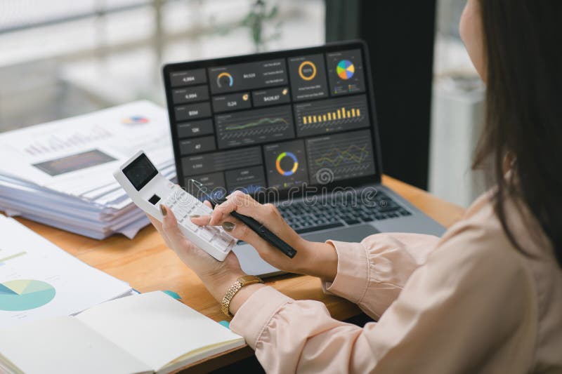 The Female Analyst Utilizes a Computer and a Dashboard for Business ...