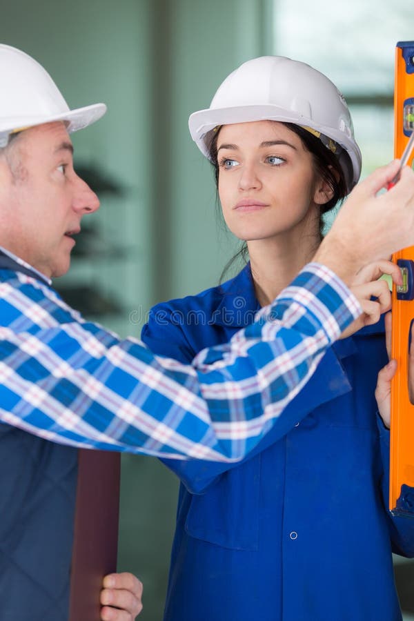 Female Apprentice Builder with Spirit Level Stock Photo - Image of ...
