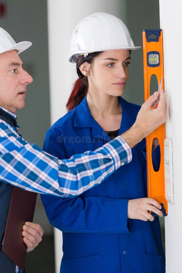 Female Apprentice and Carpenter Using Ruler Stock Image - Image of ...