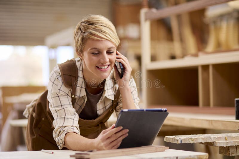 Female Apprentice with Digital Tablet Working As Carpenter in Furniture ...