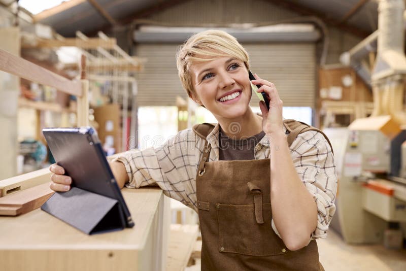 Female Apprentice with Digital Tablet Working As Carpenter in Furniture ...