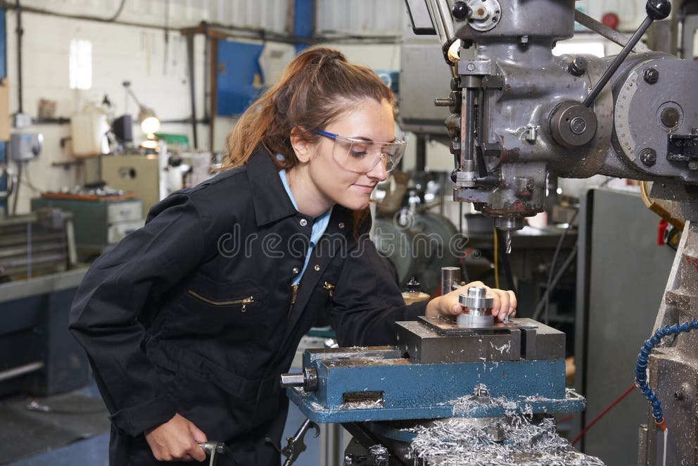 Female Apprentice Engineer Working on Drill in Factory Stock Photo ...