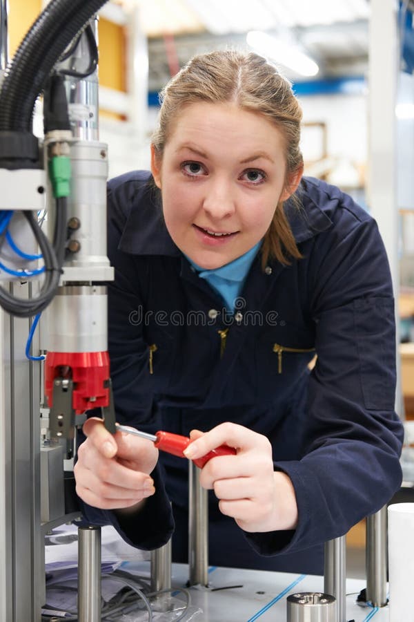 Female Apprentice Engineer Working on Machine in Factory Stock Image ...