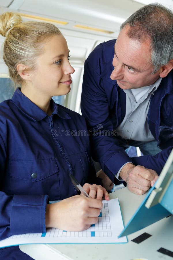 Female Apprentice Focusing on What Teacher Says Stock Photo - Image of ...