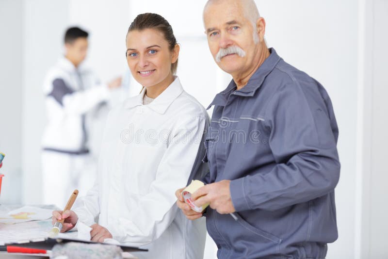 Female Apprentice and Mentor Looking at Camera Stock Photo - Image of ...