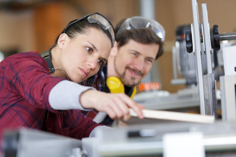 Female Apprentice Setting Up Workworking Machinery Stock Image - Image ...
