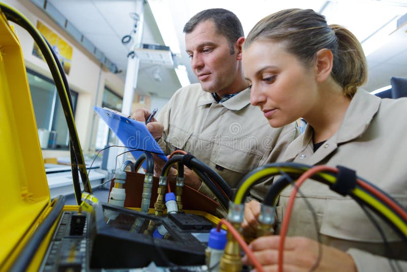 Female Apprentice Testing Wires Stock Photo - Image of occupation ...