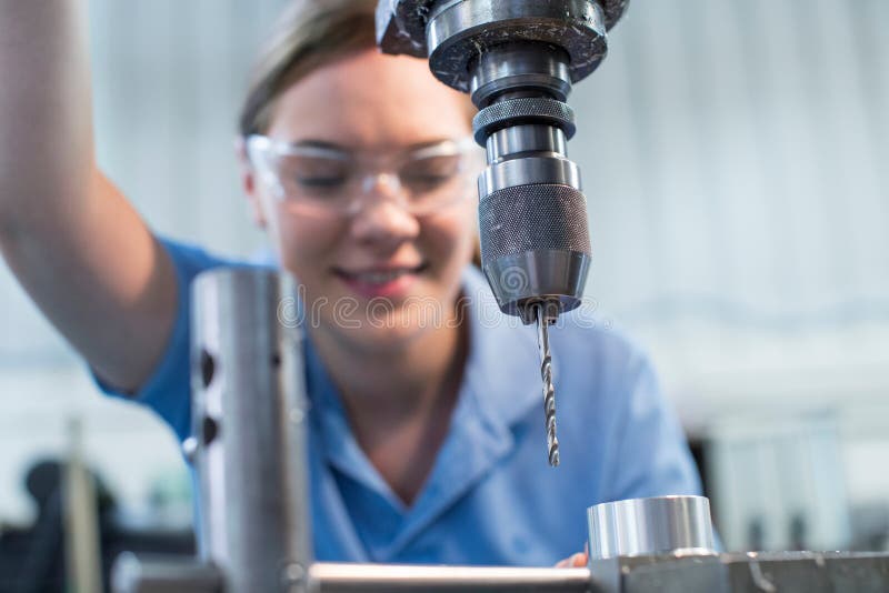 Female Apprentice Using Drill in Factory Stock Photo - Image of female ...