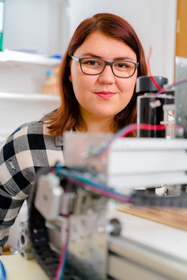 Female Apprentice Working on CNC Machinery. Stock Image - Image of ...