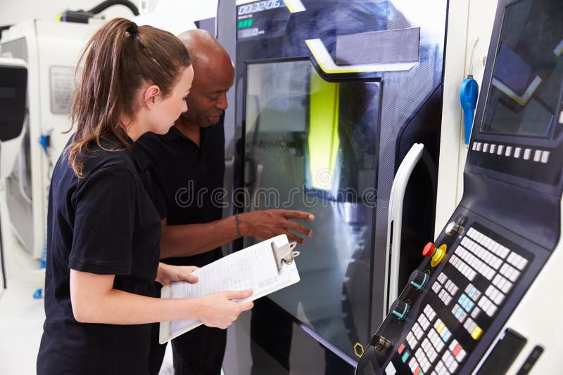 Female Apprentice Working with Engineer on CNC Machinery Stock Image ...
