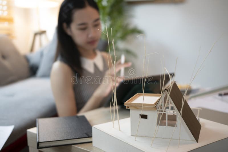Female Architect Working at Home with Tablet and Blueprints. Stock ...