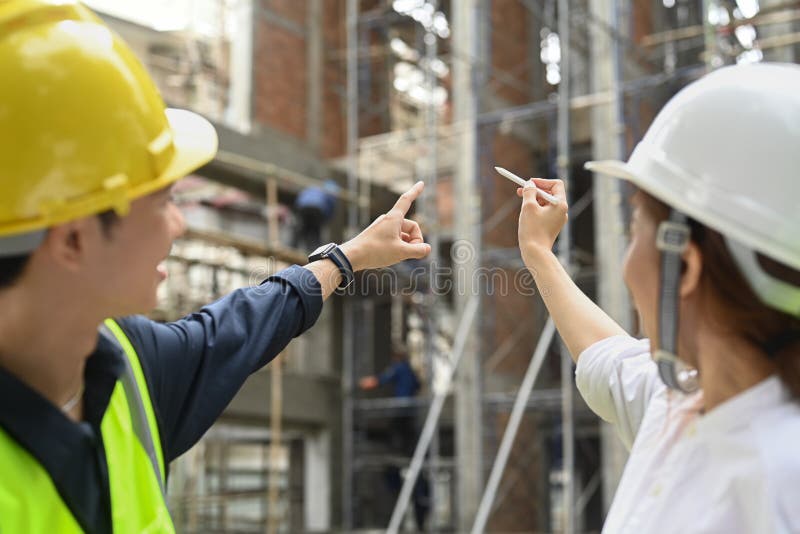 Female Architects and Civil Engineer Supervising Progress of ...
