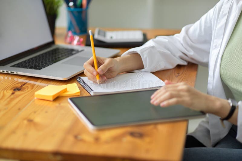 Female Architecture Taking Notes on Notepads, Looking at Tablet Screen ...