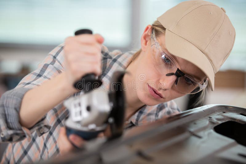 Female Artisan Using Angle Grinder Stock Photo - Image of steel ...