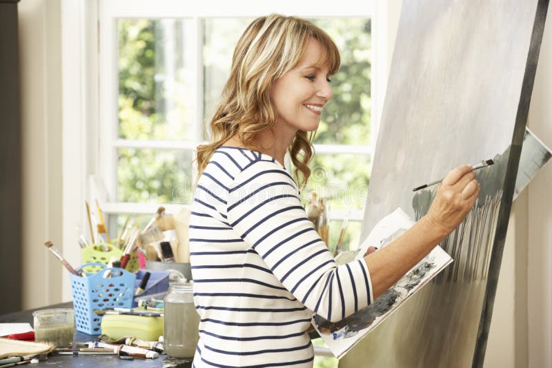 Female Artist Working on Painting in Studio Stock Image - Image of ...
