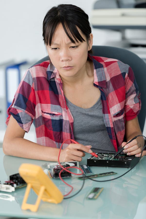 Female Asian Computer Technician Using Multimeter Stock Photo - Image ...