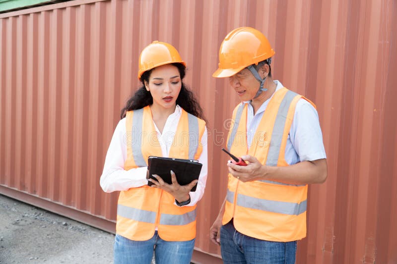 Female Asian Engineer and Foreman Engineer Loading Containers from ...