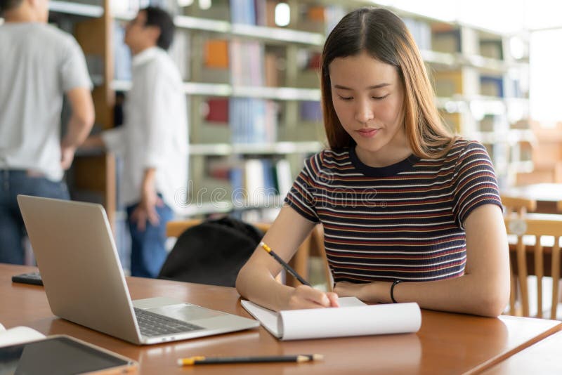 Female Asian Student Studying and Reading Book in Library Stock Image ...