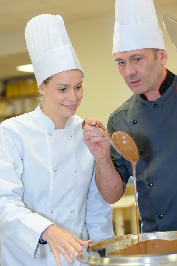 Female Assistant and Pastry Chef Making Caramel Topping Stock Image ...