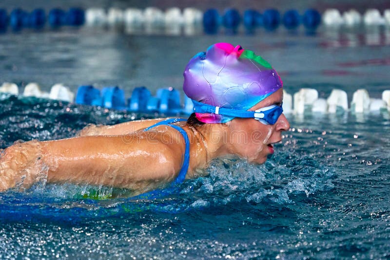 Female Athlete Swims with a Butterfly Style. Stock Photo - Image of ... Female Athlete Swims with a Butterfly Style. Stock Photo - Image of ...