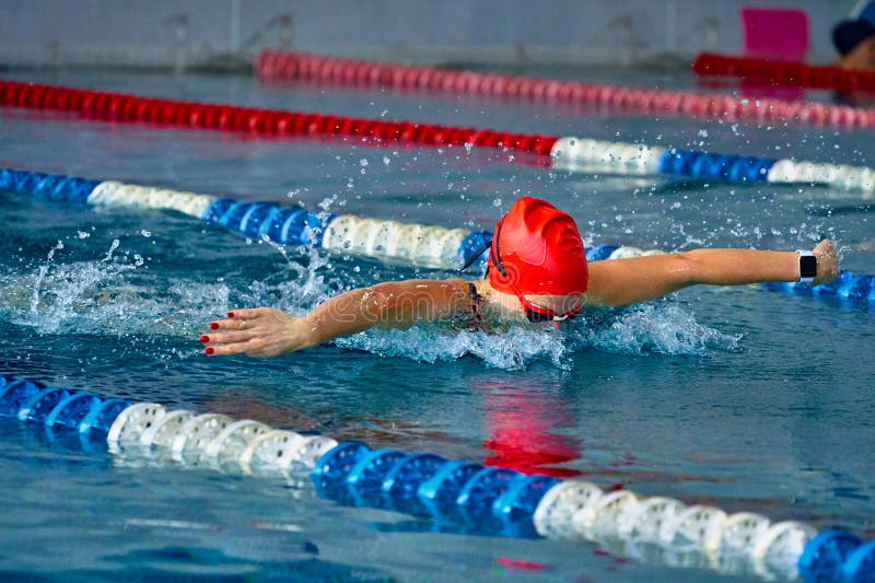 Female Athlete Swims with a Butterfly Style. Stock Photo - Image of ... Female Athlete Swims with a Butterfly Style. Stock Photo - Image of ...