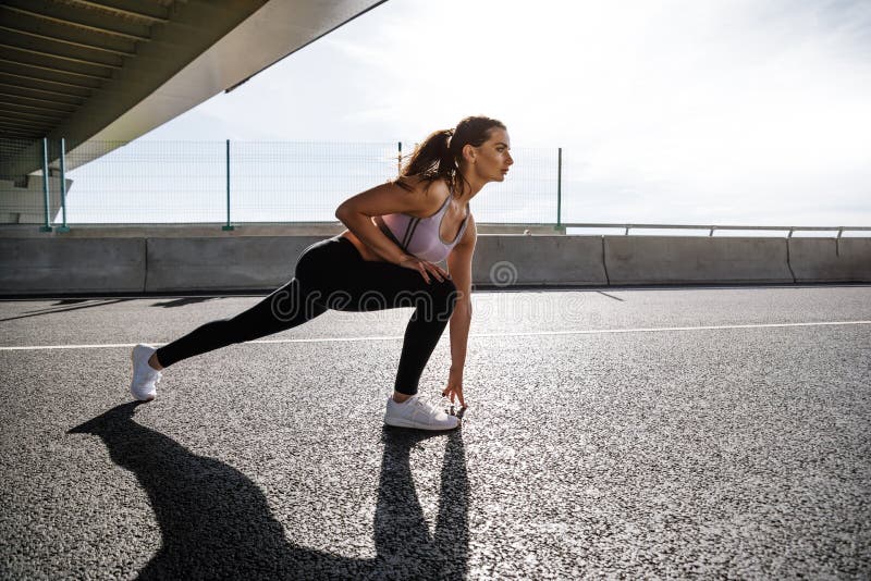 Female Athlete Warming Up Her Legs Outdoors Stock Photo - Image of ...