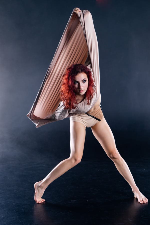 Female Athletic And Flexible Aerial Circus Artist With Redhead Dancing