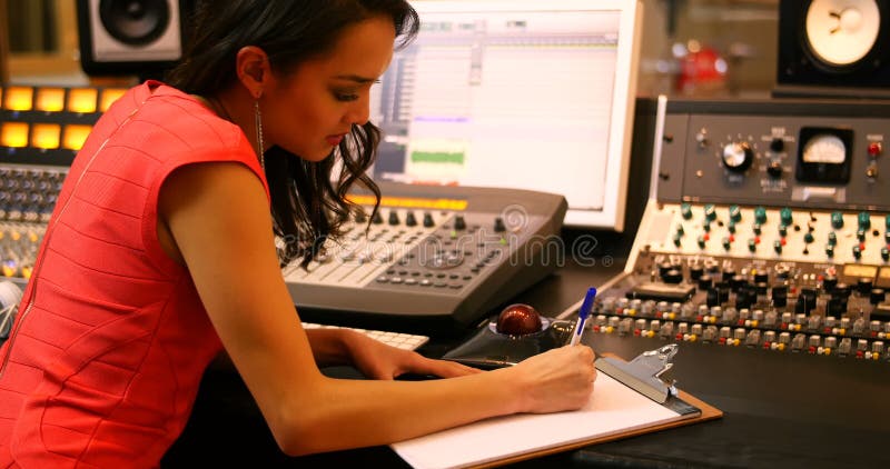 Female Audio Engineers Writing on Clipboard Stock Footage - Video of ...